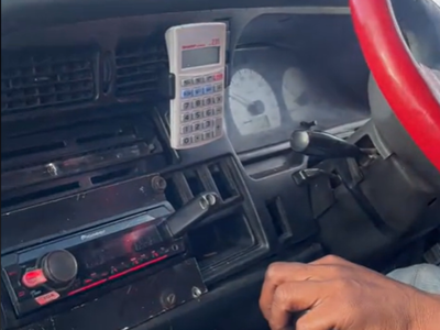 Only in SA: Taxi driver uses car phone holder for calculator