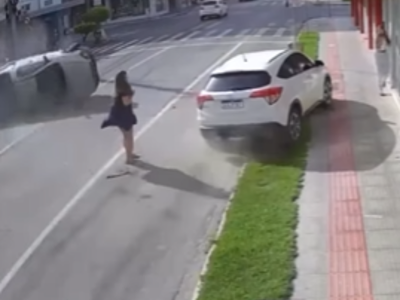 Woman unscathed as car crash misses her by centimetres