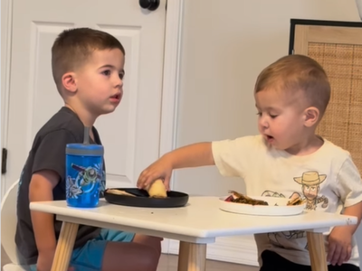 Little bro tries to swipe big bro's snack