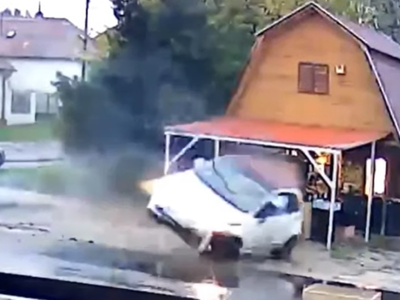 WATCH: Car hits the curb and cartwheels in front of house
