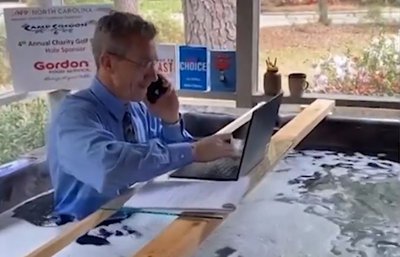 Man sets up work station in hot tub