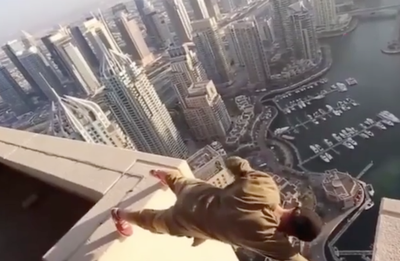 Guy does INSANE stunts on high risen buildings