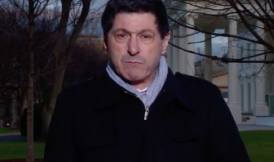 Can you spot the mystery behind this reporter’s hands?