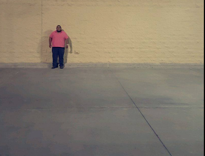 Guy stands under sign, wishes it to fall so he can sue