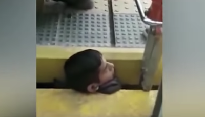 Mind the gap! Man gets head stuck between train and platform