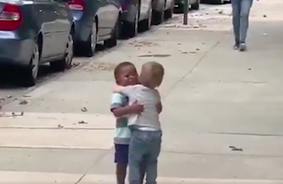 Two toddlers running to hug each other in the street will make you smile