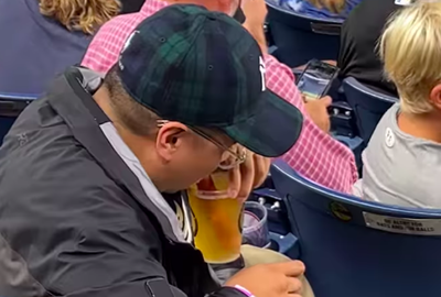 WATCH: Baseball fan enjoys his beer by using sausage as a straw