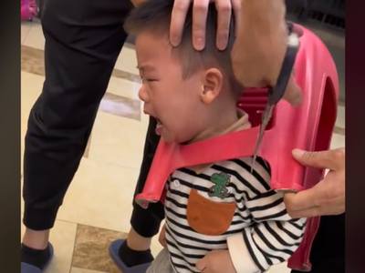 Toddler gets his head stuck inside a barstool