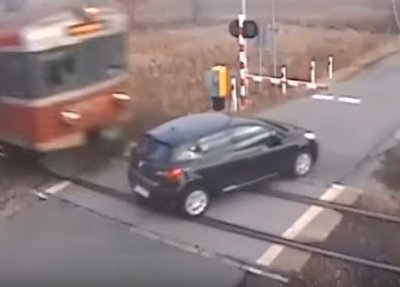 Silly driver tries to beat train, gets smashed