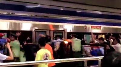 Watch: Chinese commuters push train to save man's life