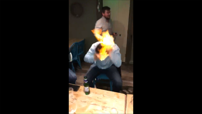 WATCH: Men set fire to their heads and pass it on to the next person