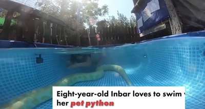 Young Israeli girl loves swimming with her pet python